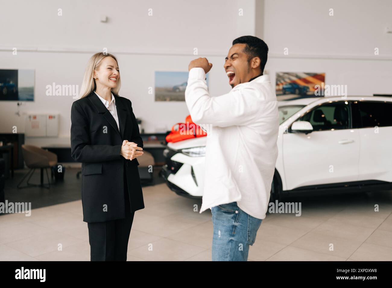 Happy excited African-American customer celebrating successful car ...