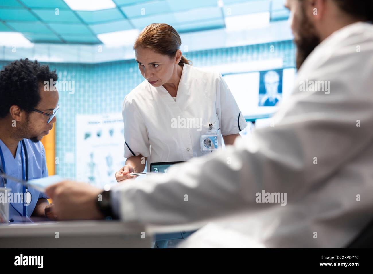 Diverse medical staff reviewing test results and discussing innovative ...