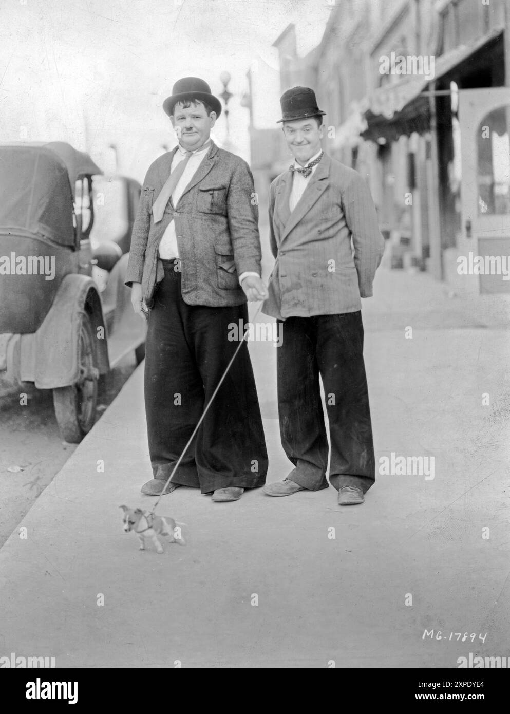 A candid publicity photo of STAN LAUREL and OLIVER HARDY and a dog ...