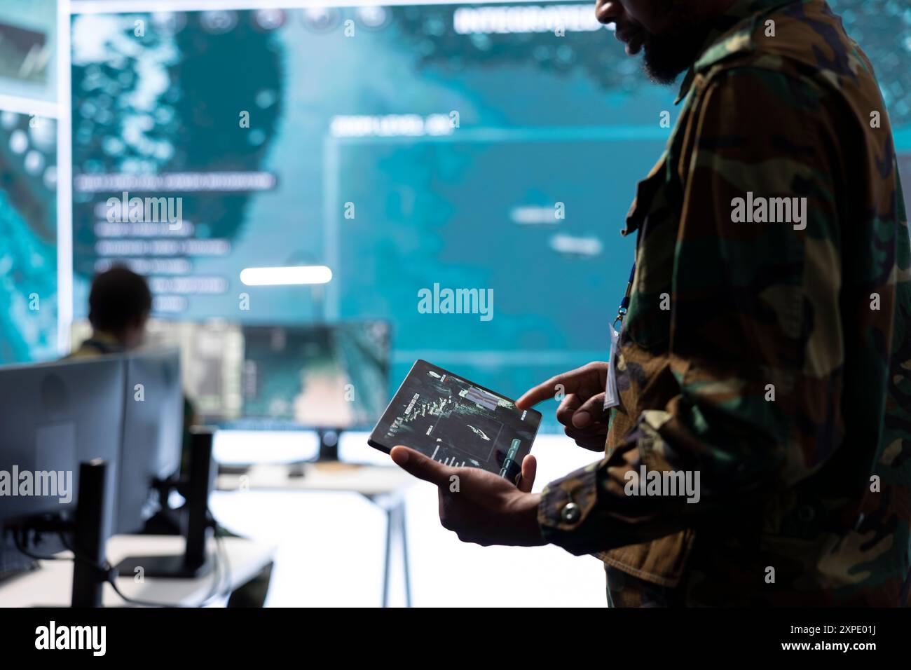 High tech military office with soldiers analyzing real time data ...