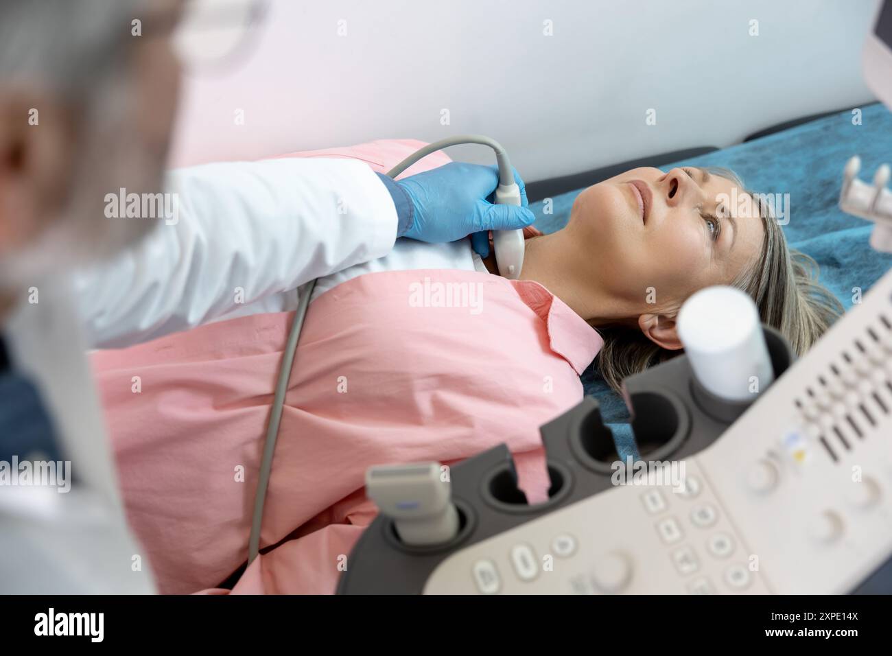 Female doctor performing thyroid hi-res stock photography and images ...