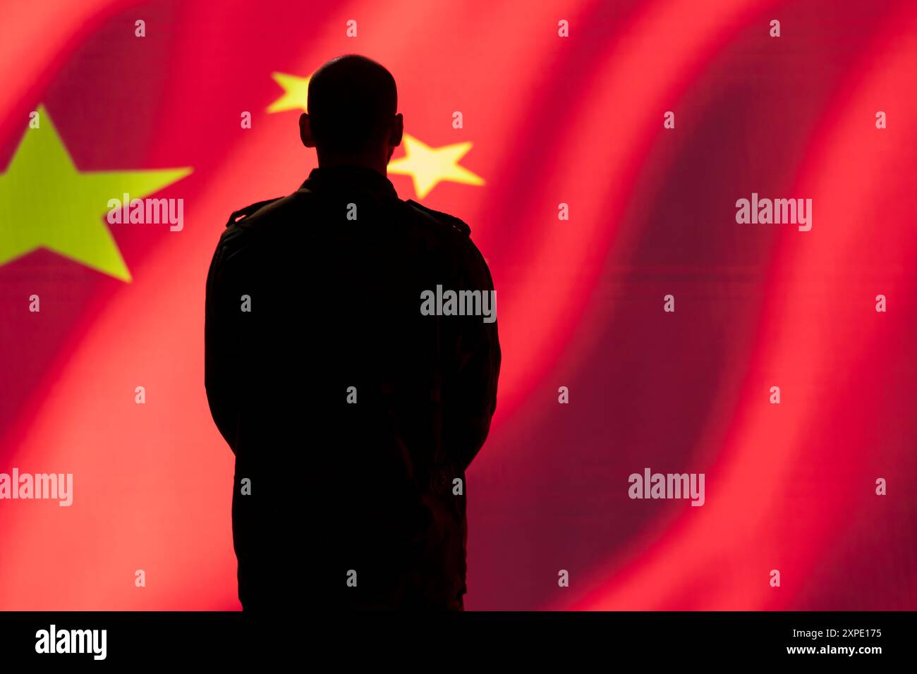 Chinese military soldier standing proud in front of flag, feeling pride ...