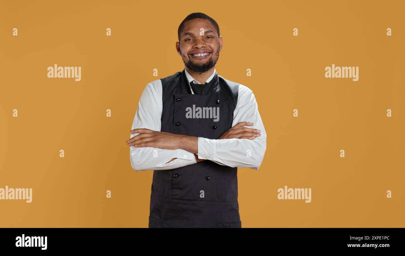 Portrait of restaurant waiter wearing professional uniform and apron ...