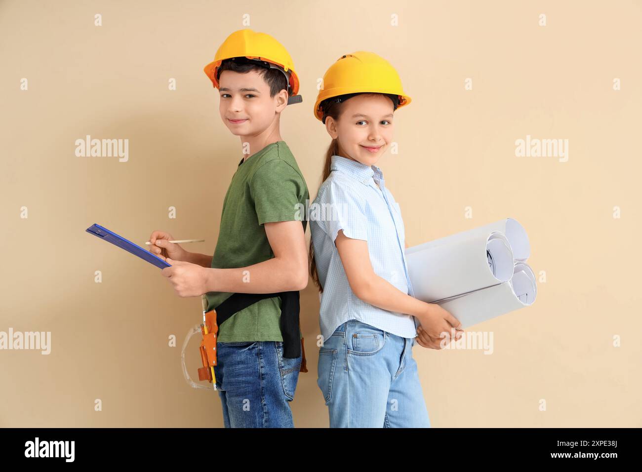 Little architects with house plans and tools on beige background Stock ...