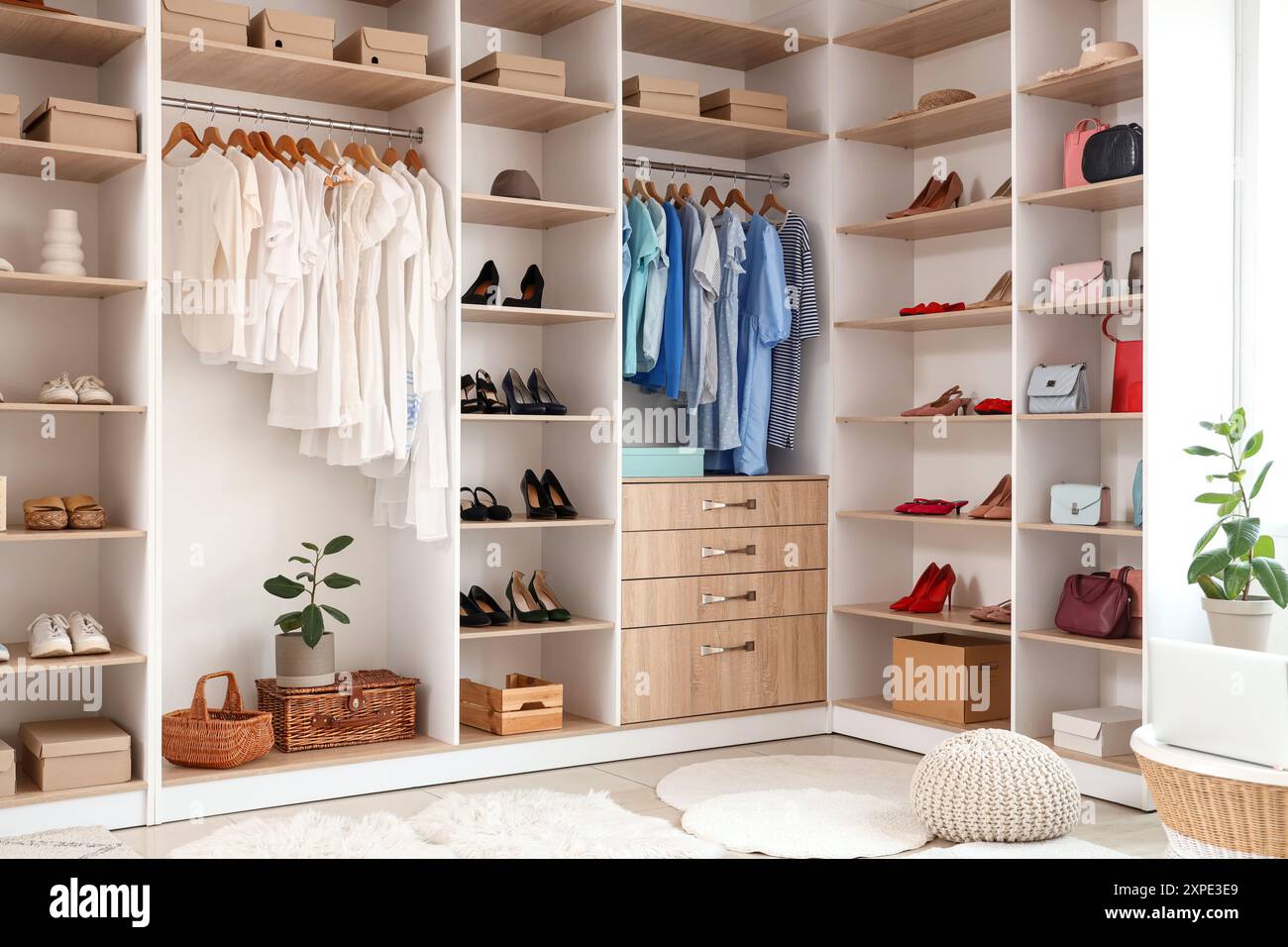 Wardrobe with different clothes and accessories in dressing room Stock ...