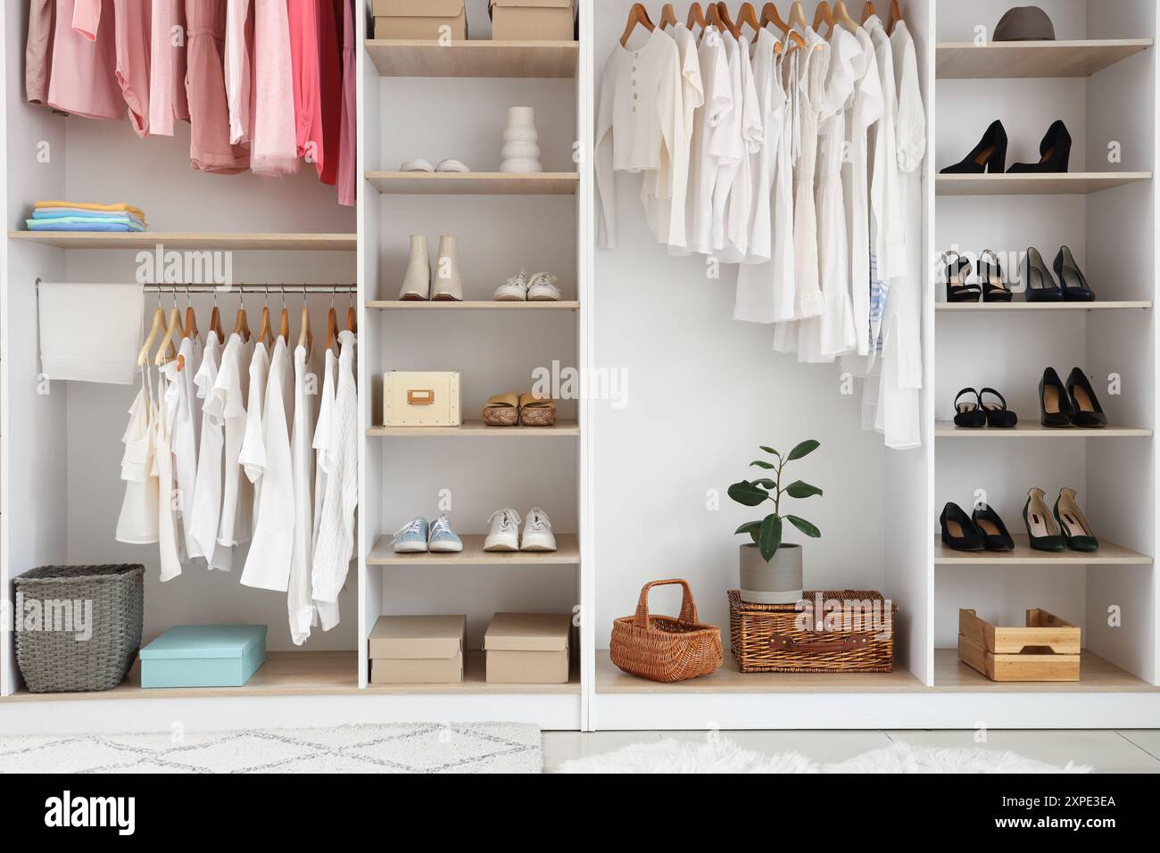 Wardrobe with different clothes and accessories in dressing room Stock ...