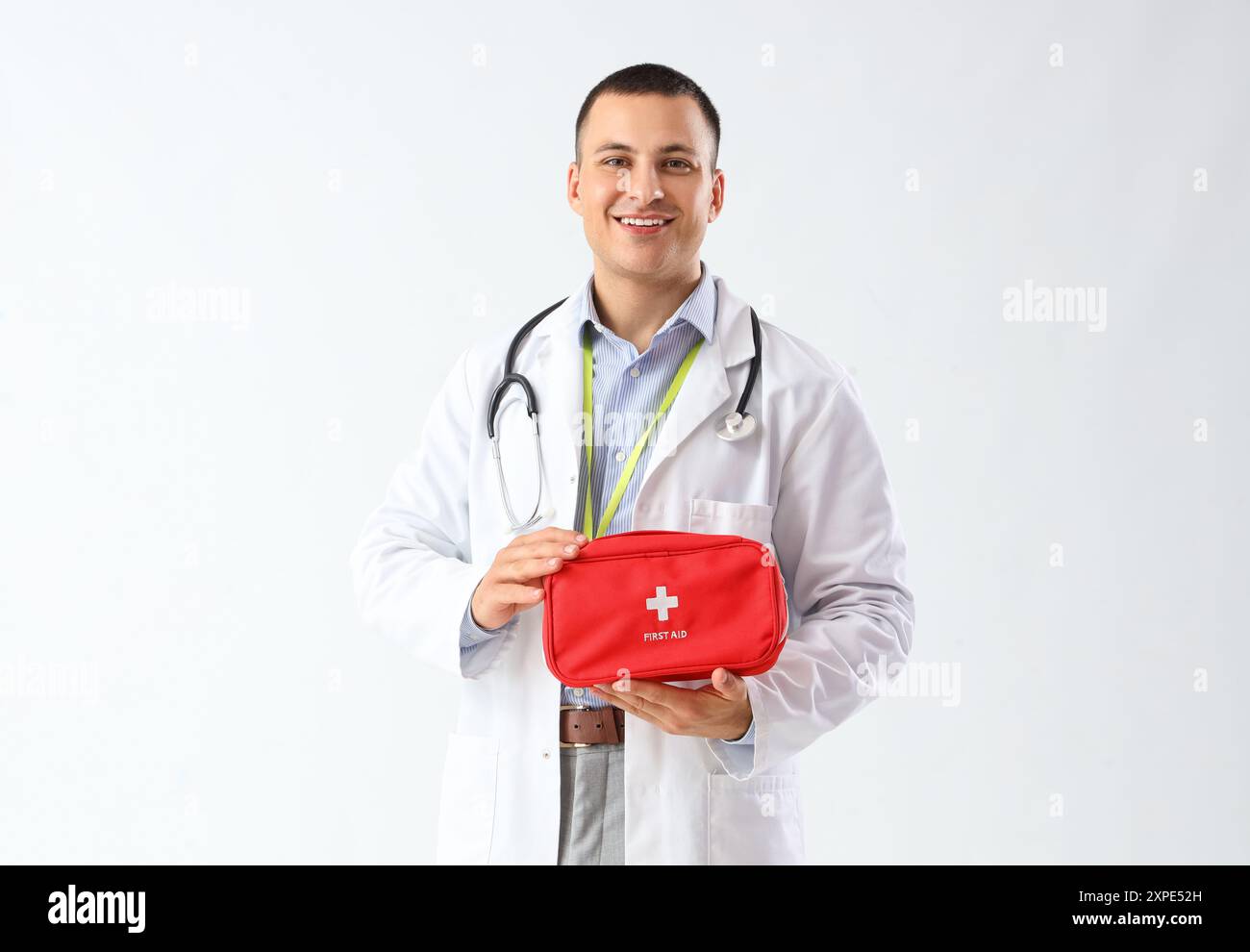 Handsome doctor with first aid kit on white background Stock Photo - Alamy