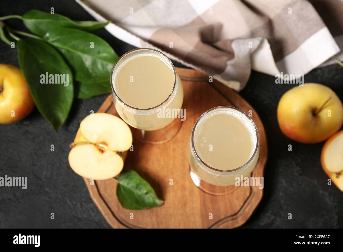 Glasses of fresh apple kvass and fruits on black background Stock Photo - Alamy