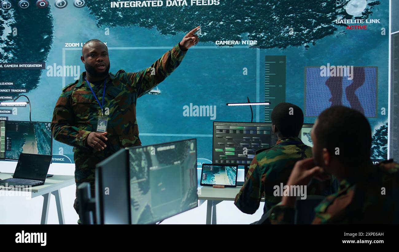 Military personnel operate advanced systems in a command center ...