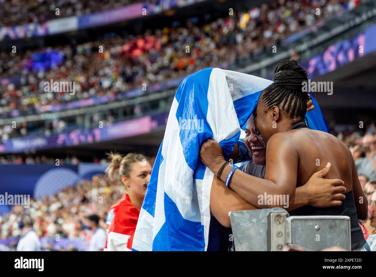 Emmanouil Karalis, of Greece, hidden under a Greek flag, celebrates ...