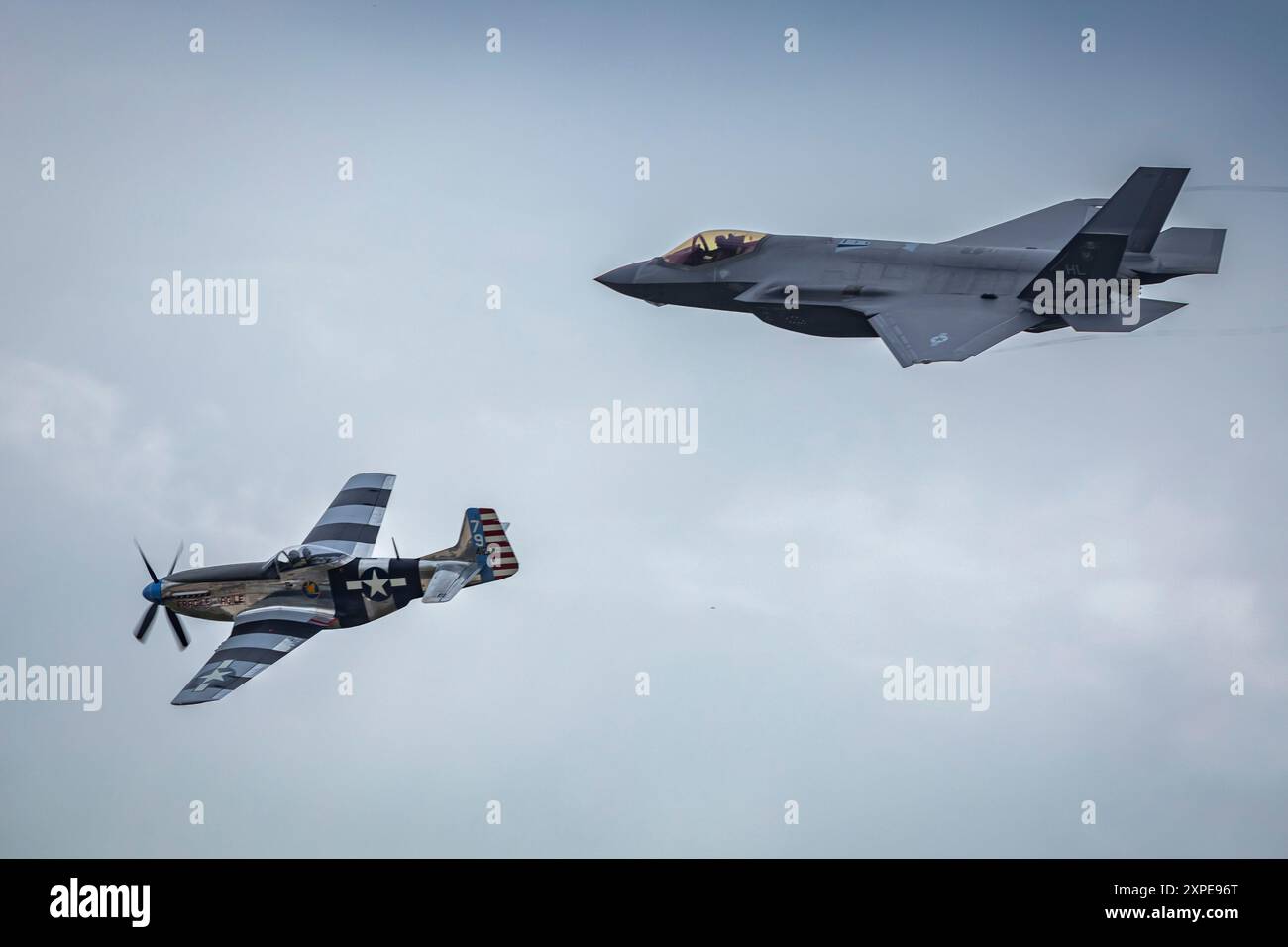 An F-35A Lightning II and P-51 Mustang p-51 Mustang fly together as ...