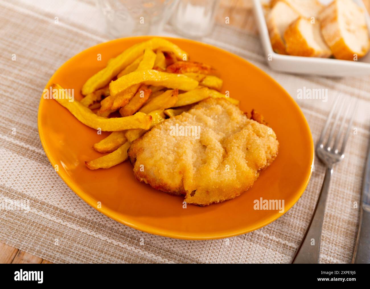 Roasted breaded pork fillet with fried potatoes for dinner Stock Photo ...