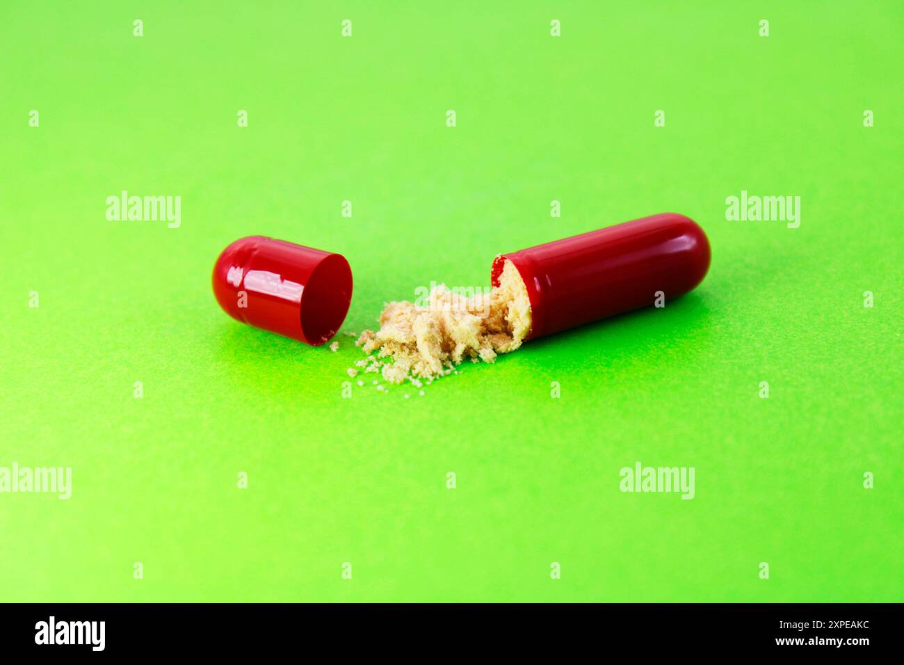 Open red medicine capsule showing its contents Stock Photo - Alamy