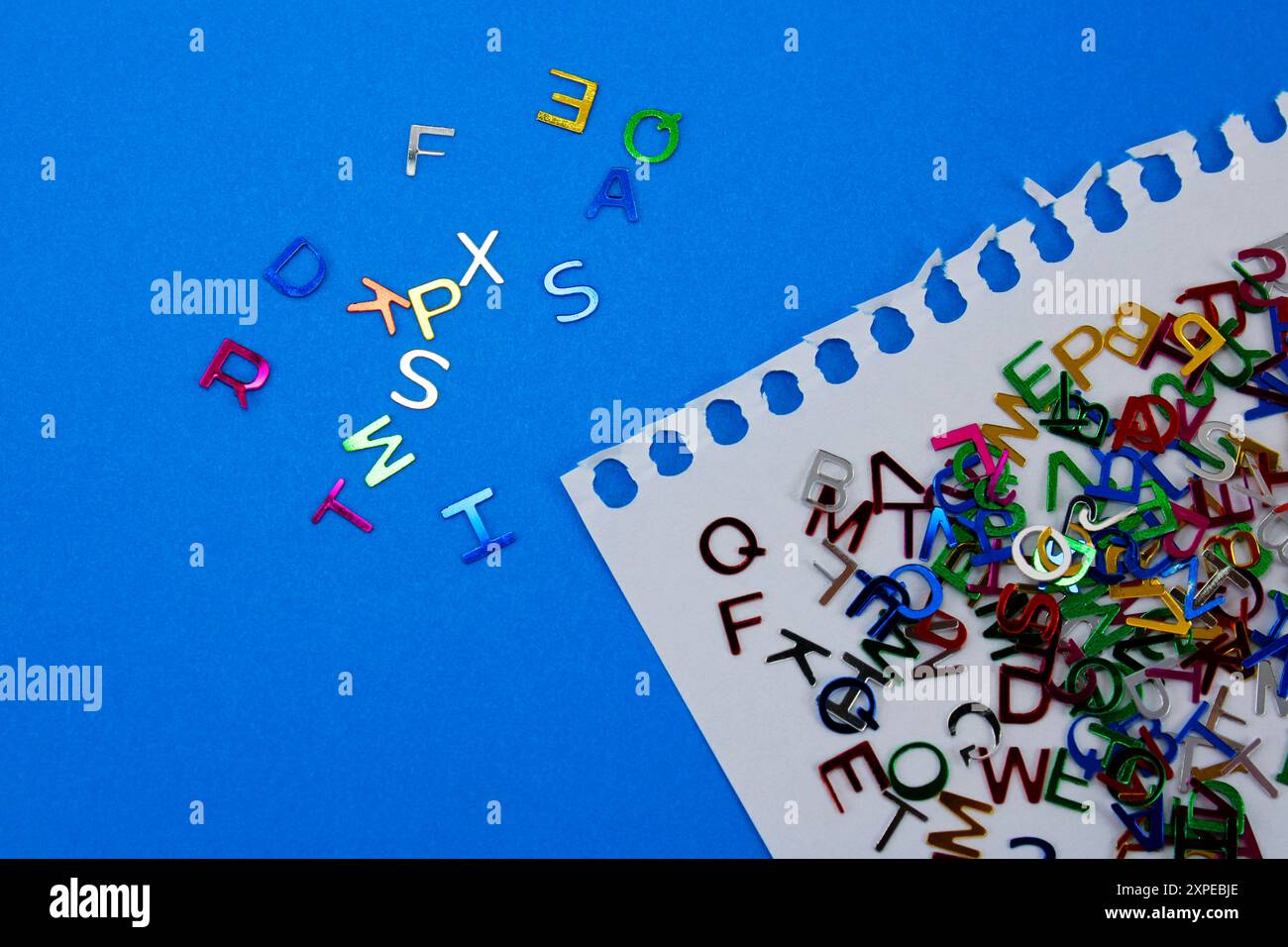Sheet of paper and colorful letters Stock Photo - Alamy