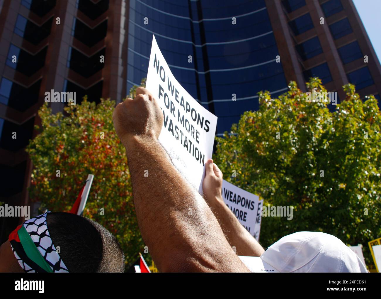 A demonstrator holds up a sign from JVP Action at a “Rally for Return ...