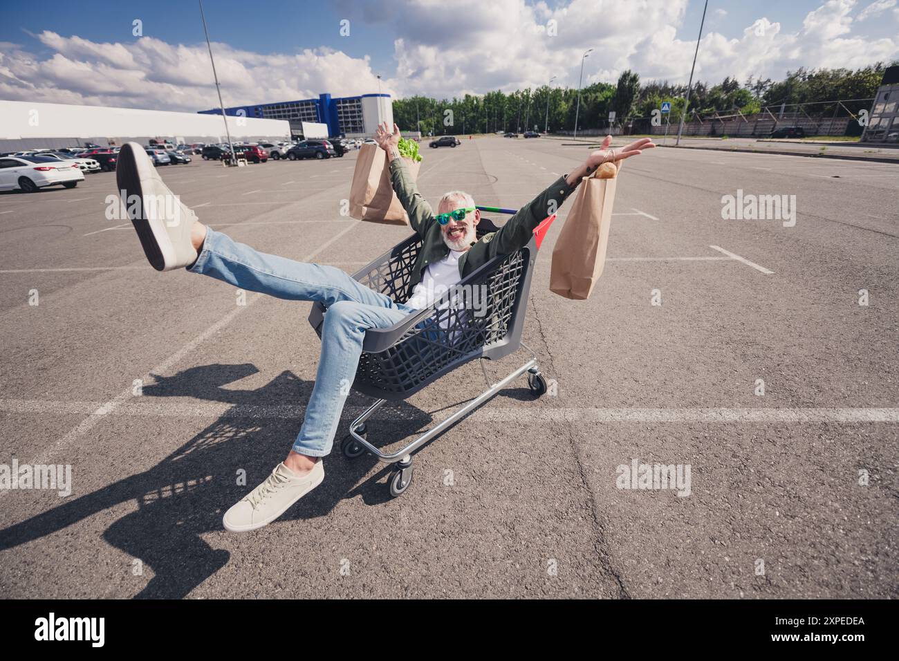 Full size photo of pensioner man riding shopping cart loading groceries ...
