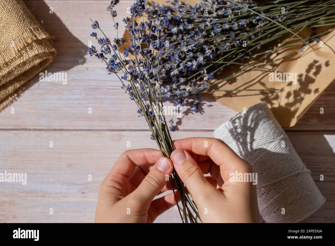 Woman creating bouquets of dry lavender flowers. Process of making ...