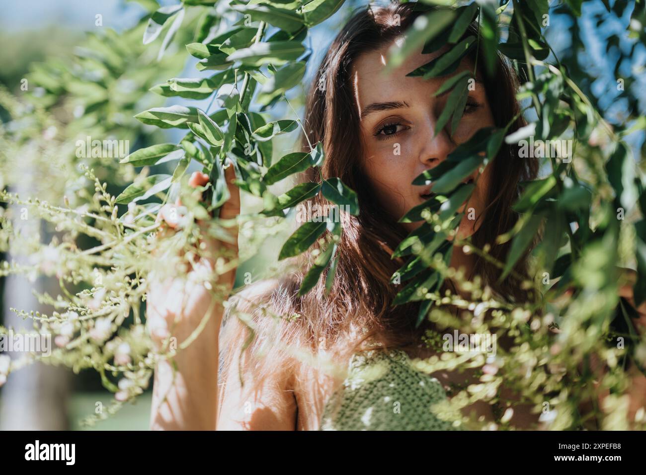 Female peeking through leaves hi-res stock photography and images - Alamy