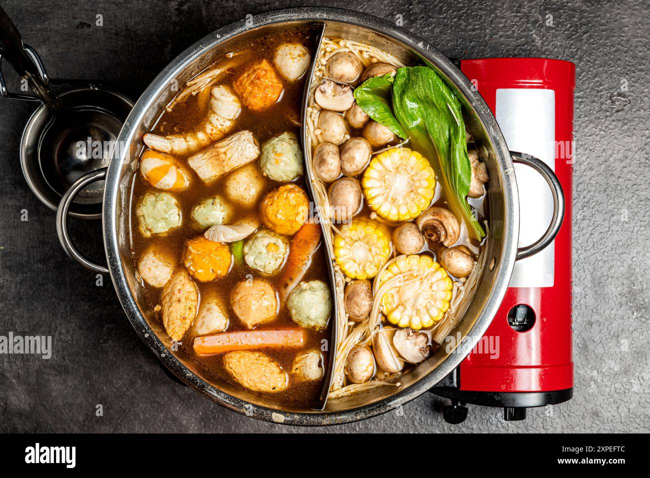 A red pot with two different types of food in it. The food is a mix of ...