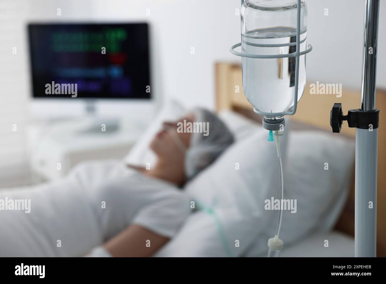 Coma patient. Young woman with intravenous drip in hospital bed ...