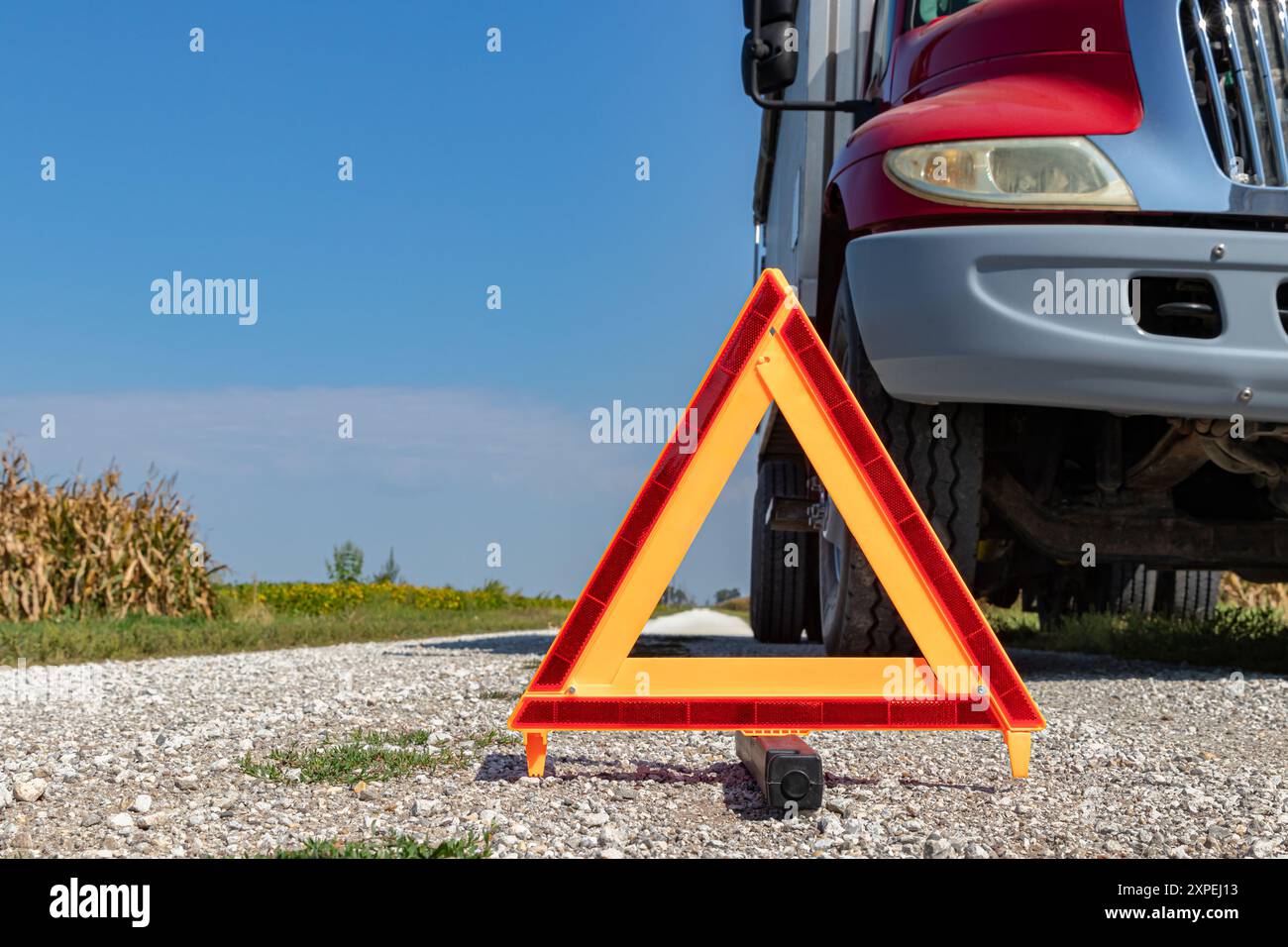 Grain truck on side of road with warning triangle. Farm truck safety ...
