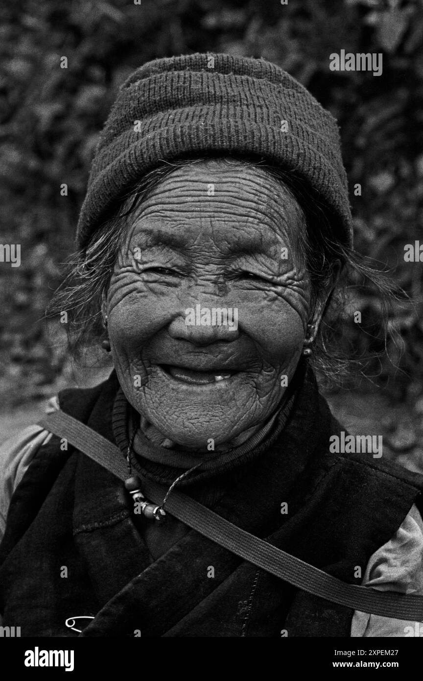 An old Sherpa woman rests along the trail - Solu District of Nepal ...