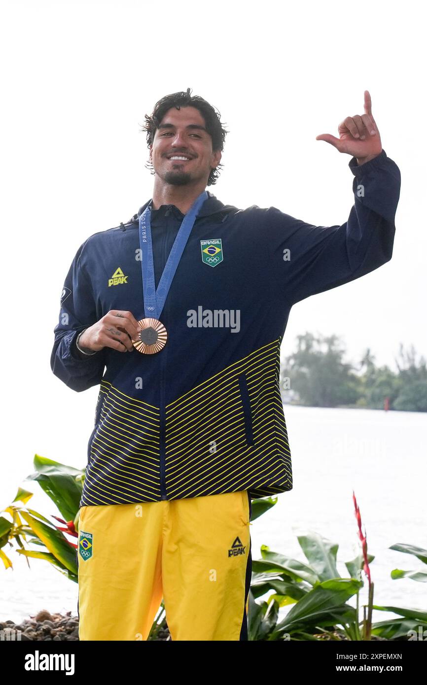 Bronze medalist Gabriel Medina, of Brazil, celebrates on the podium ...