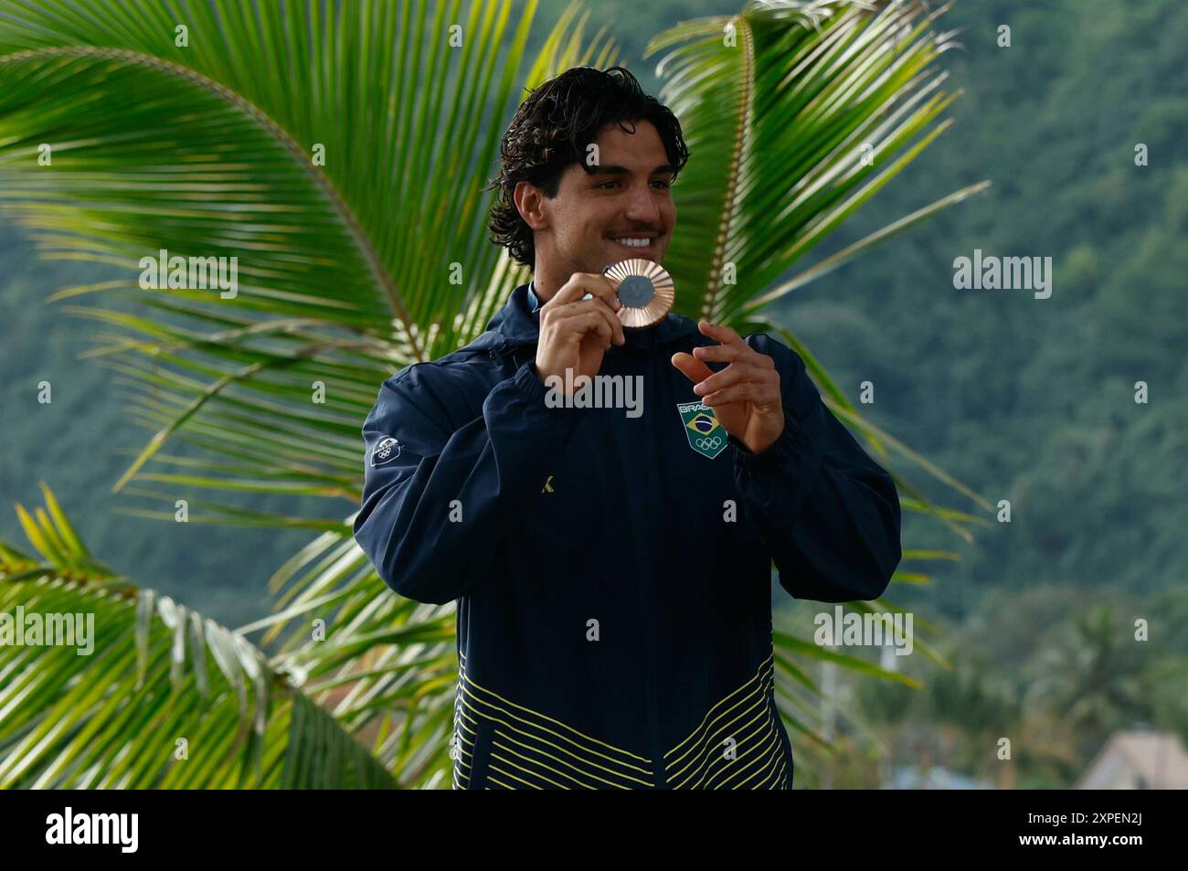 Bronze medalist Gabriel Medina, of Brazil, reacts at the men's surfing ...
