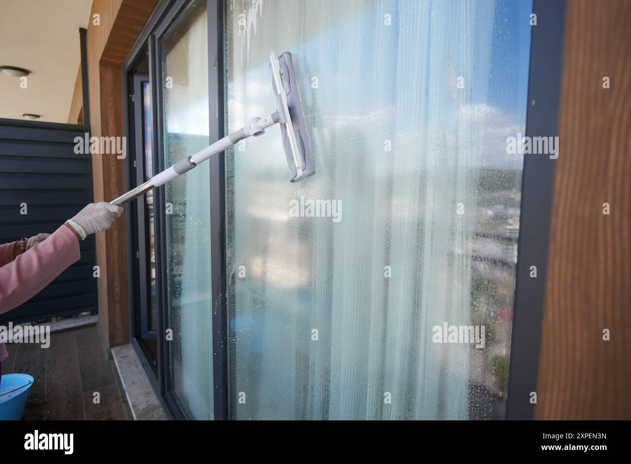 Rubber squeegee cleans a soaped window Stock Photo - Alamy