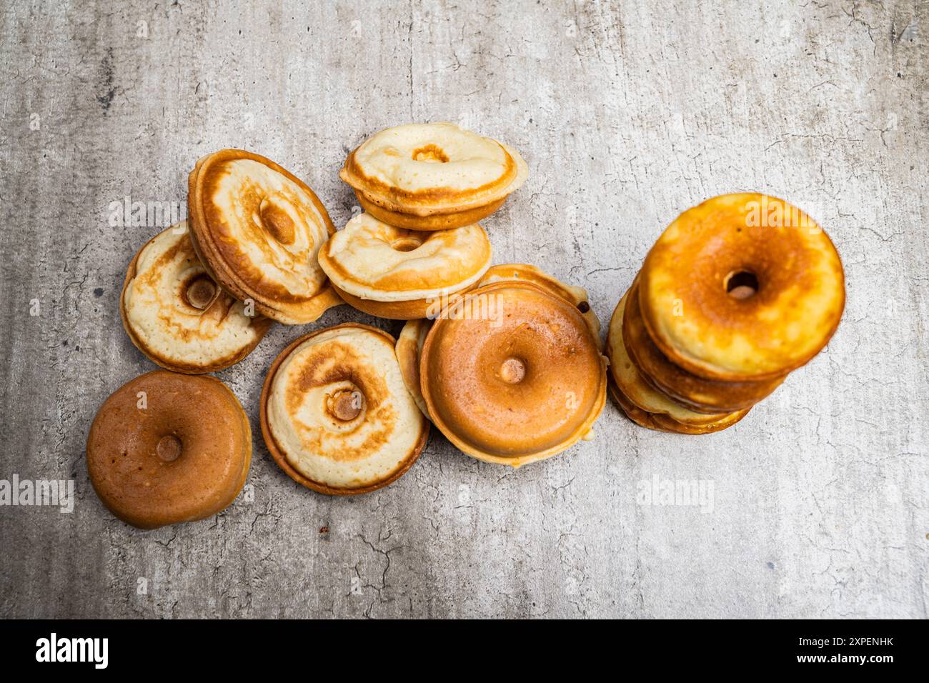 A stack of donuts with a variety of flavors and sizes. Concept of ...