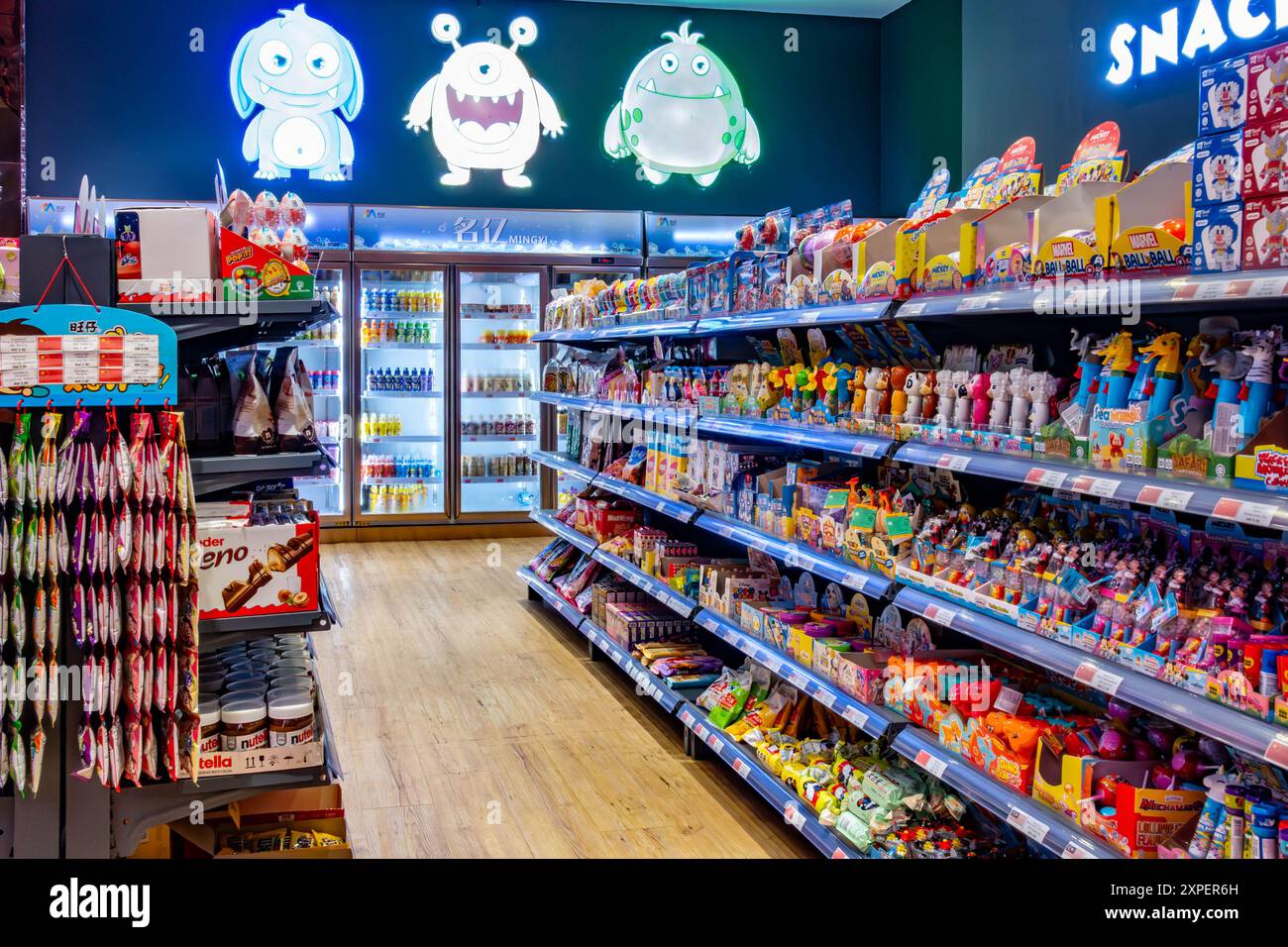 An aisle in a shop in Penang, Malaysia with shelves displaying sweets ...