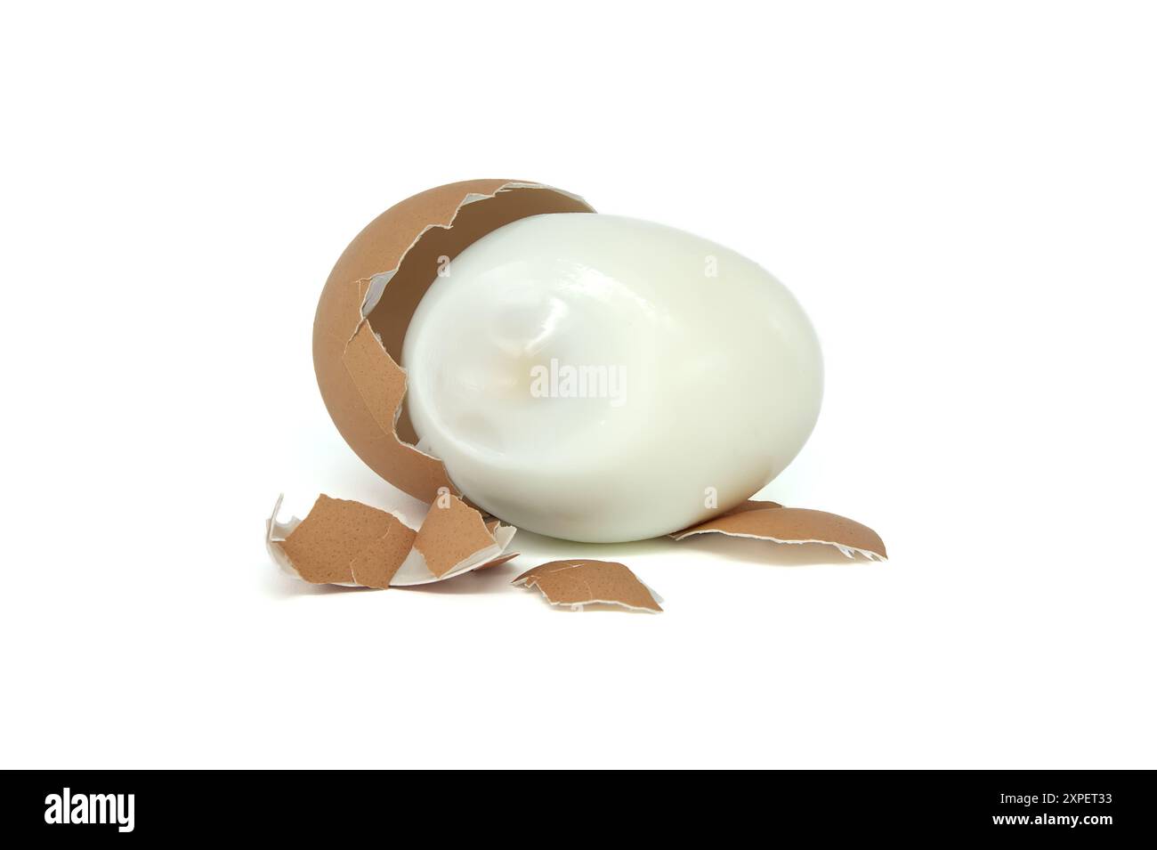 Egg in the process of being peeled, isolated on a white background ...