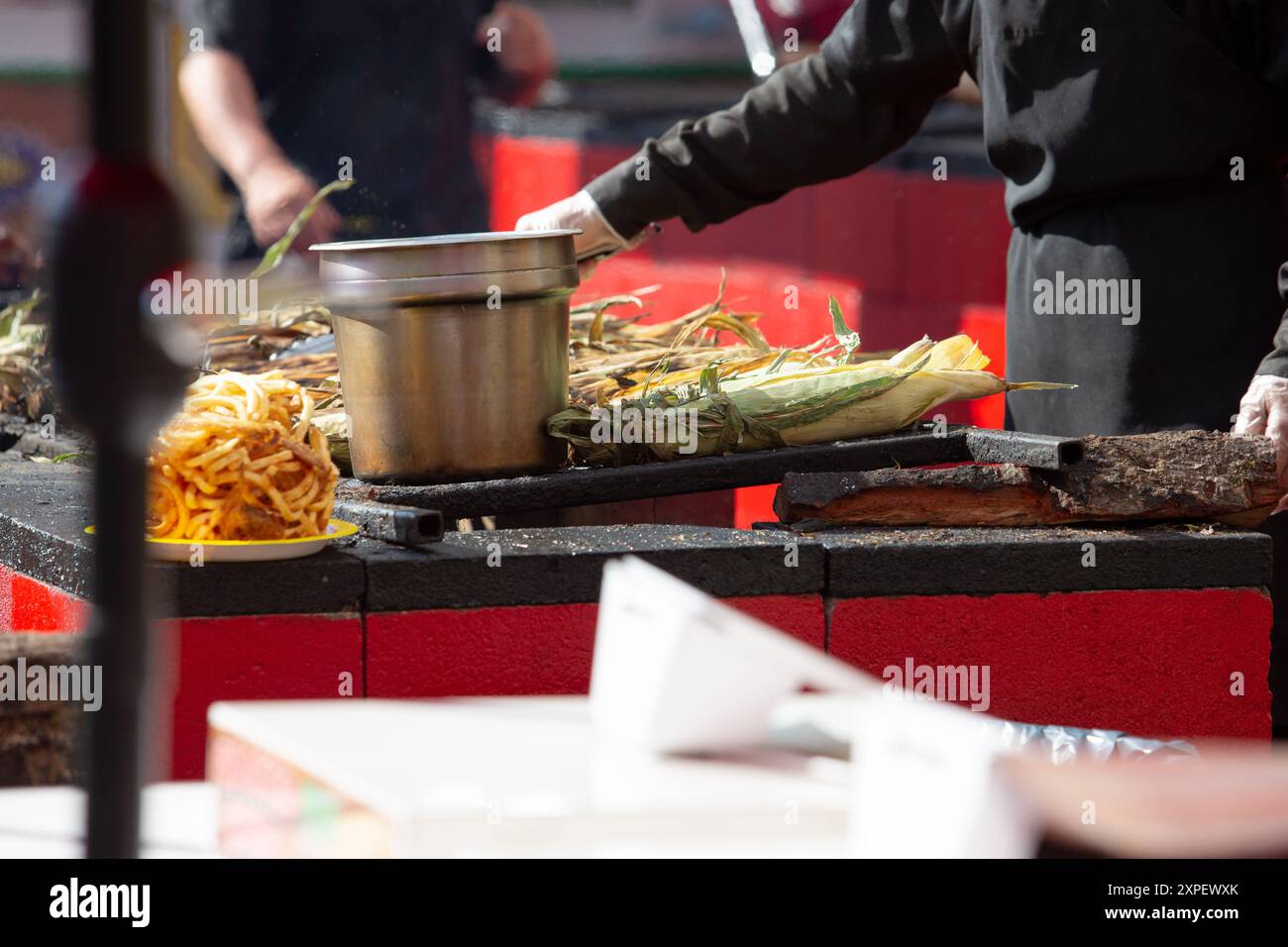 A view of a pit master preparing corn on a grill Stock Photo - Alamy