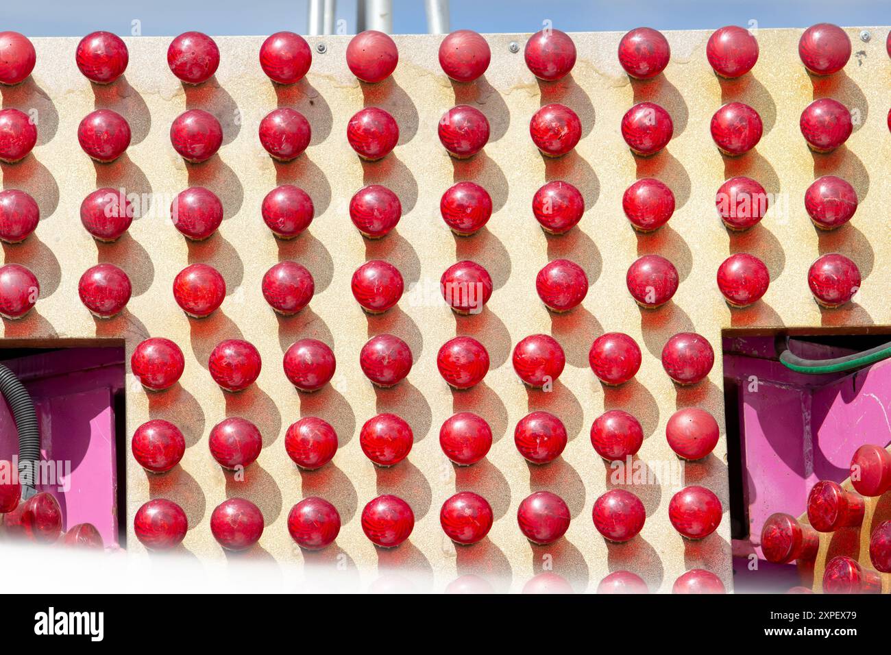 A view of a lightbulb design on the side of a carnival ride Stock Photo ...