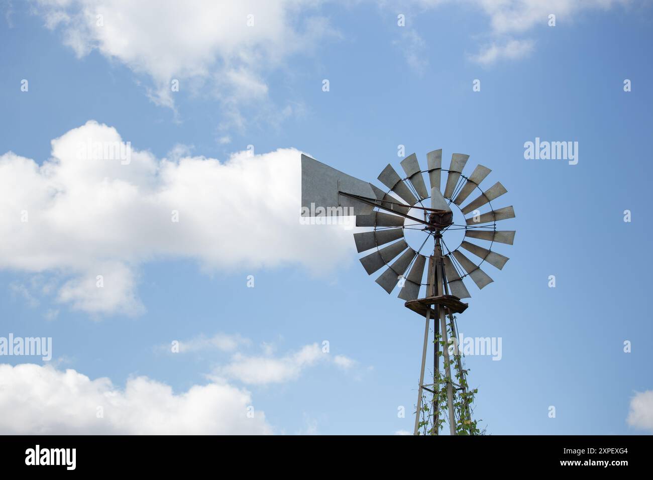 A view of a windmill structure against a blue sky Stock Photo - Alamy