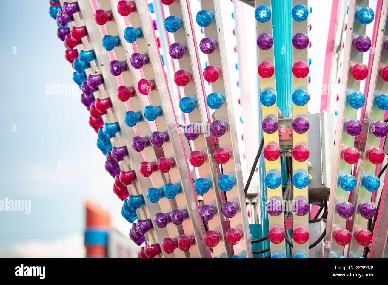 A view of a lightbulb design on the side of a carnival ride Stock Photo ...