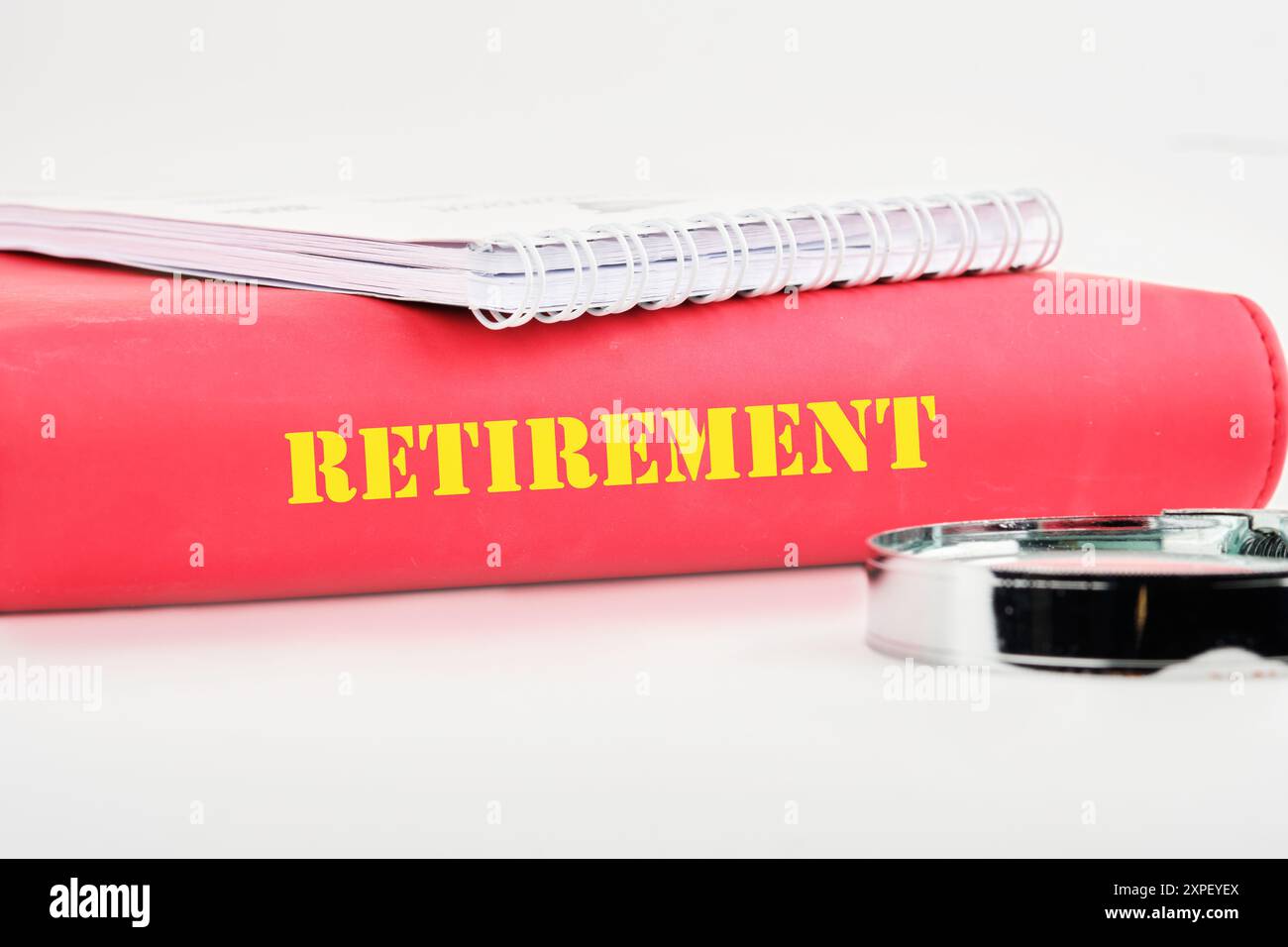 Retirement concept. RETIREMENT word on the cover of the book on a white ...