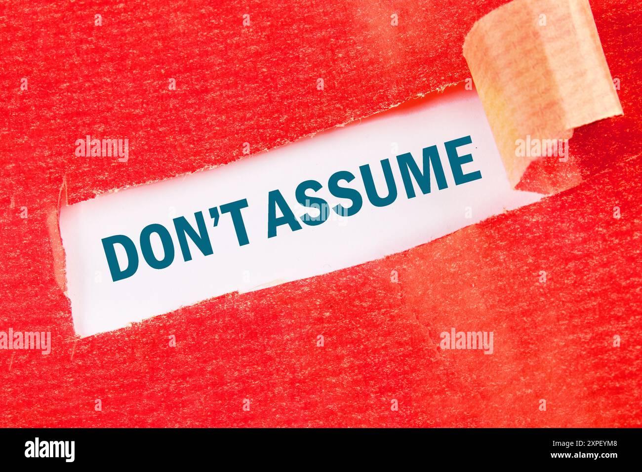 The words Don't Assume on a white background under torn paper Stock ...