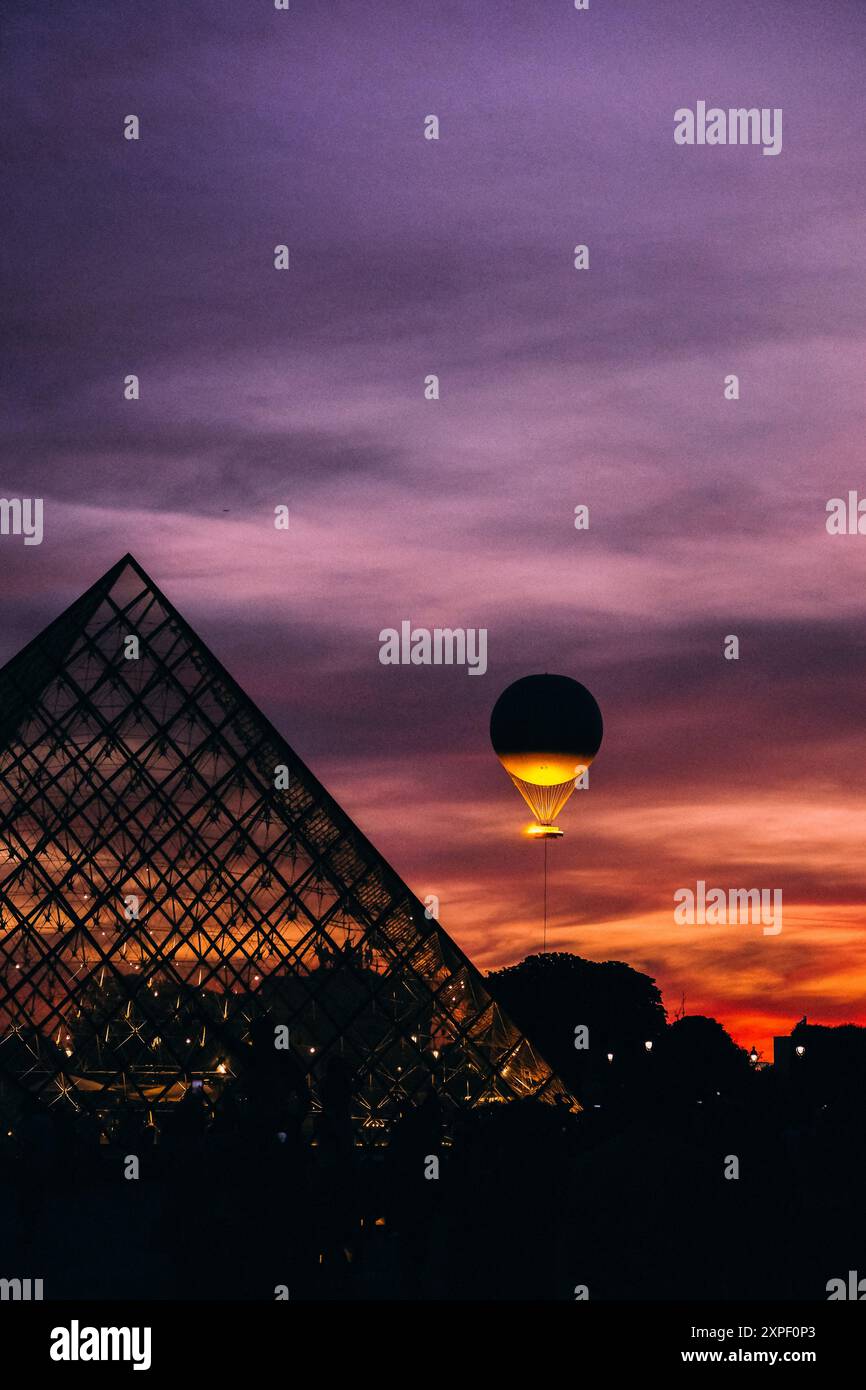 The cauldron, with the Olympic flame lit, lifts off while attached to a ...