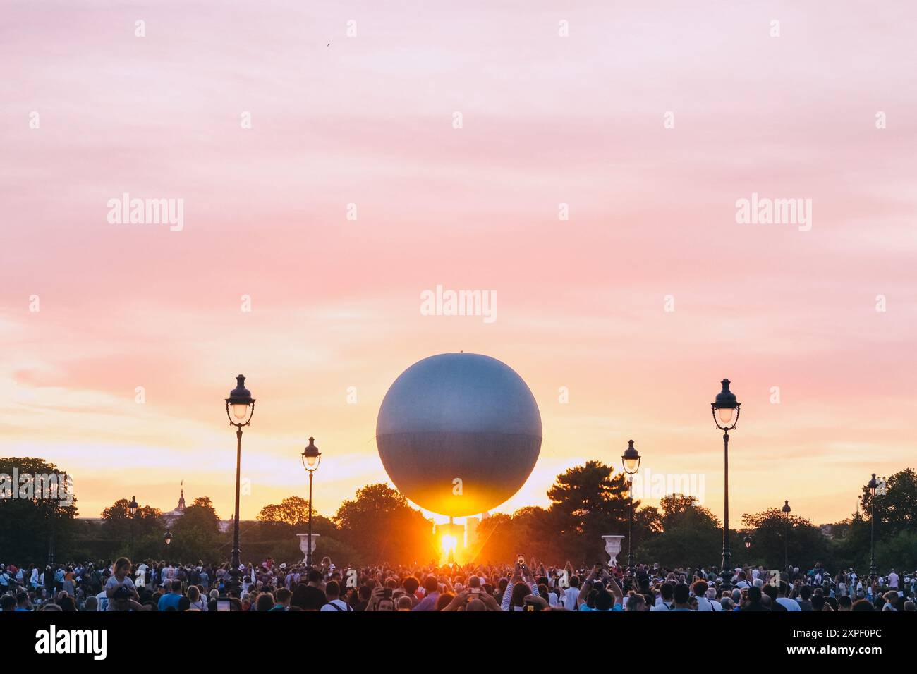 The cauldron, with the Olympic flame lit, lifts off while attached to a ...