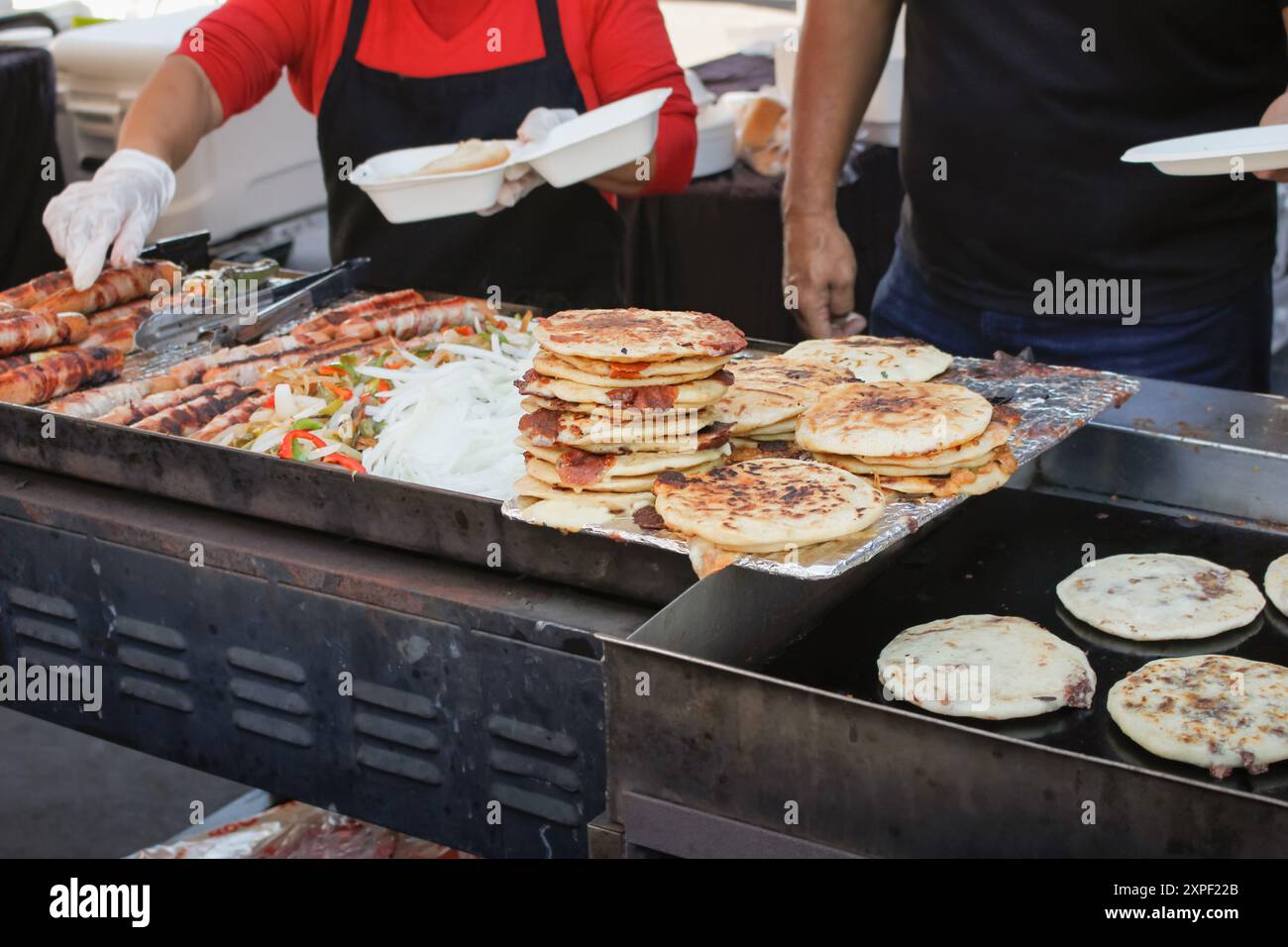 A view of several pupusas cooking on a griddle Stock Photo - Alamy