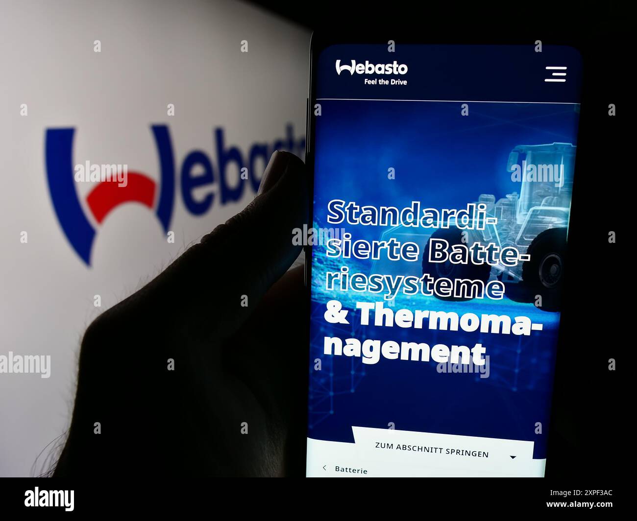 Person holding smartphone with webpage of German automotive company ...