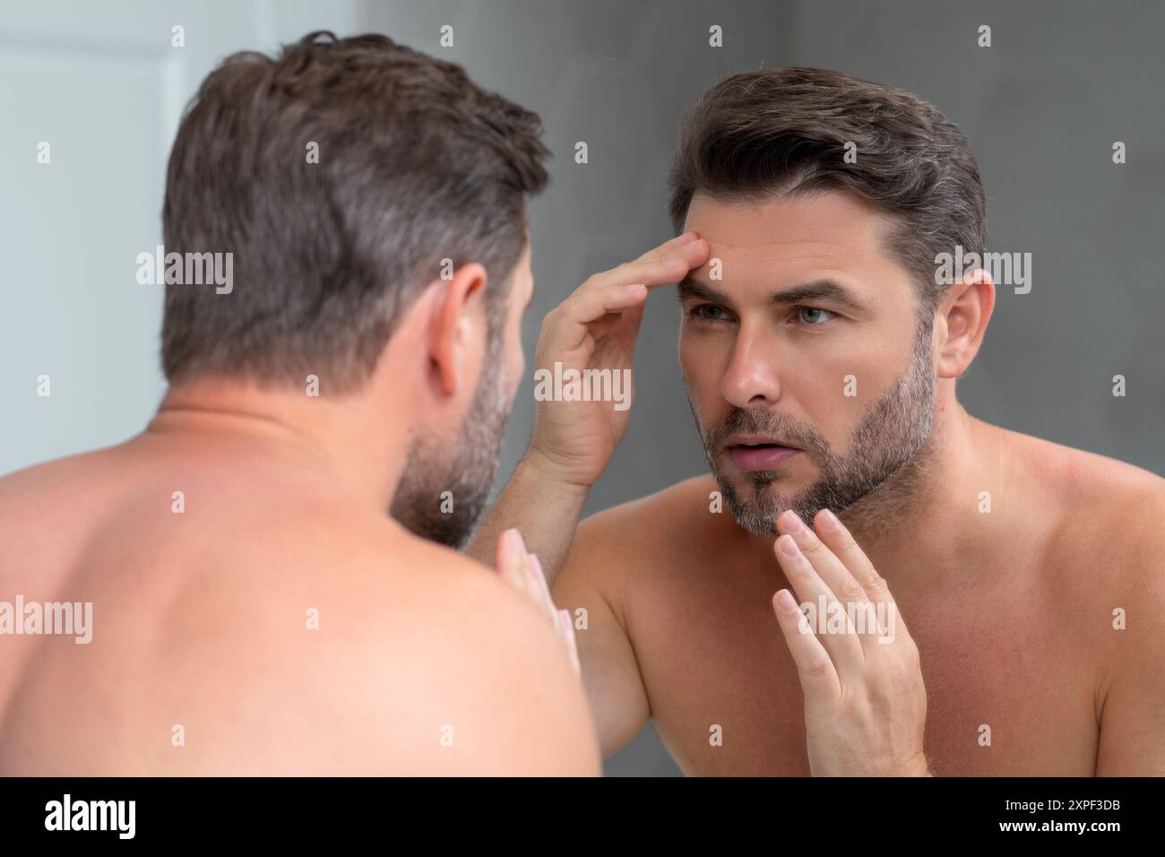 Mens beauty. Cream treatment for mens face. Beauty routine. Face of a beauty man with perfect ...