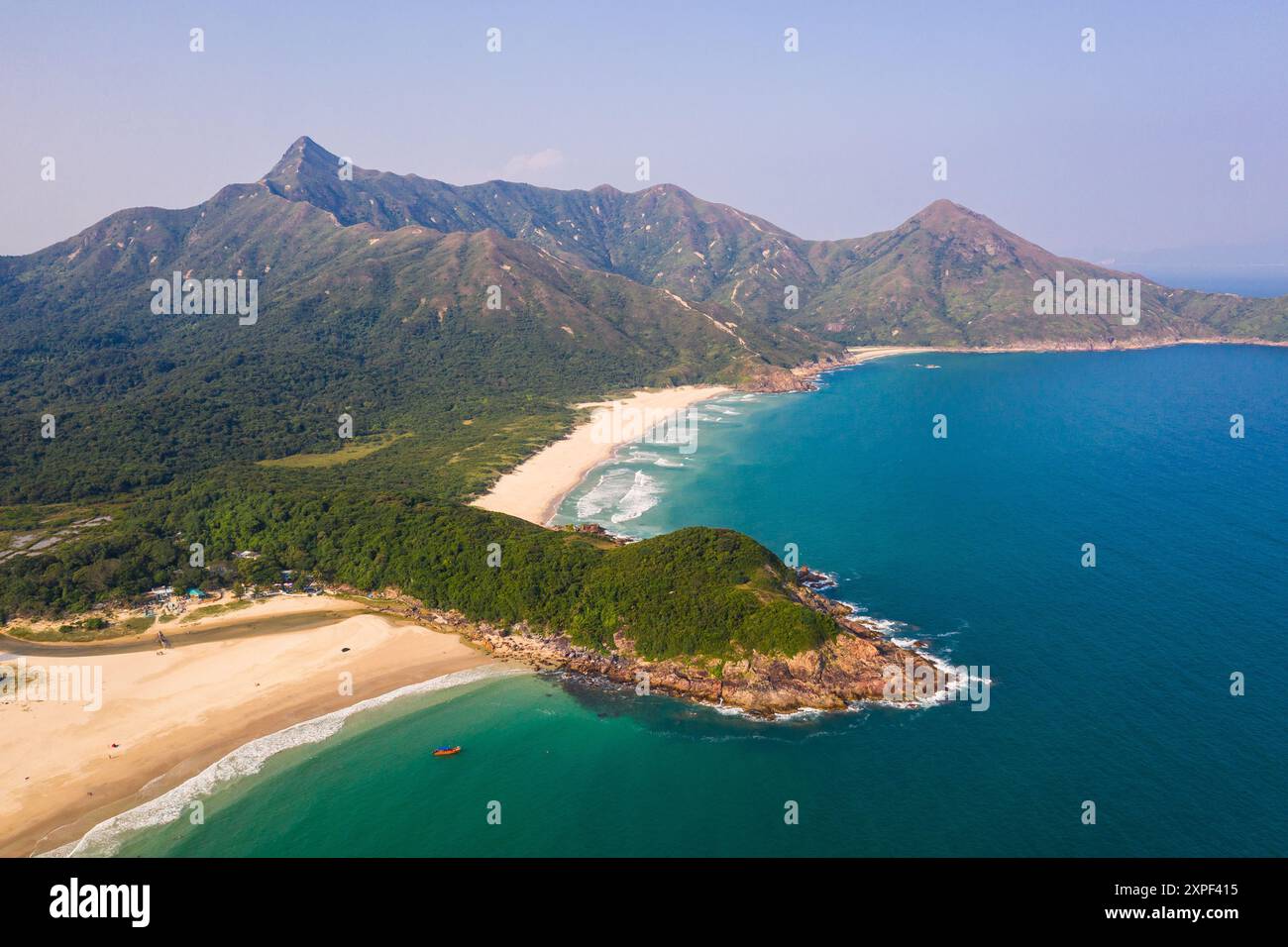 Hong Kong: Dramatic landscape of the Sai Kung peninsula with sandy beaches and the Sharp peak in ...