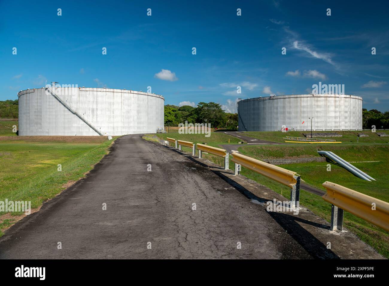 Oil refinery tanks storage in a grassy field - stock photo Stock Photo - Alamy