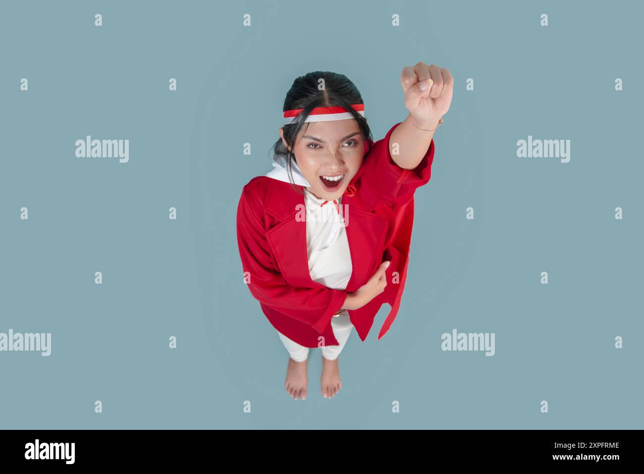 Happy young Indonesian woman wearing country flag on her back and ...