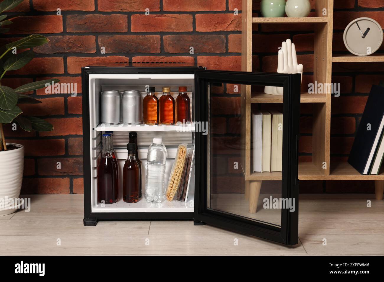 Mini refrigerator with drinks and snacks indoors Stock Photo - Alamy