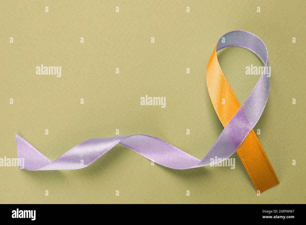 World Psoriasis Day. Orange and orchid awareness ribbon as symbol of ...