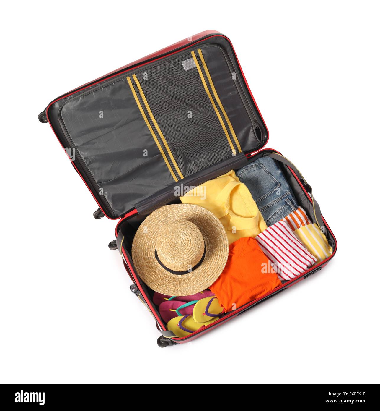 Open suitcase with clothes packed for travelling isolated on white, top ...