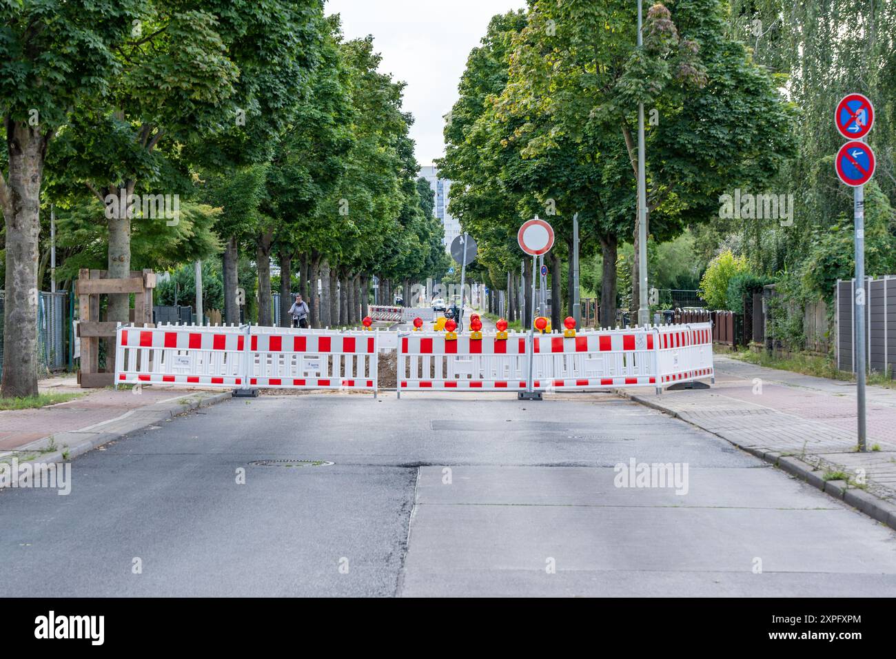 The road is blocked by a construction fence and traffic lights during ...